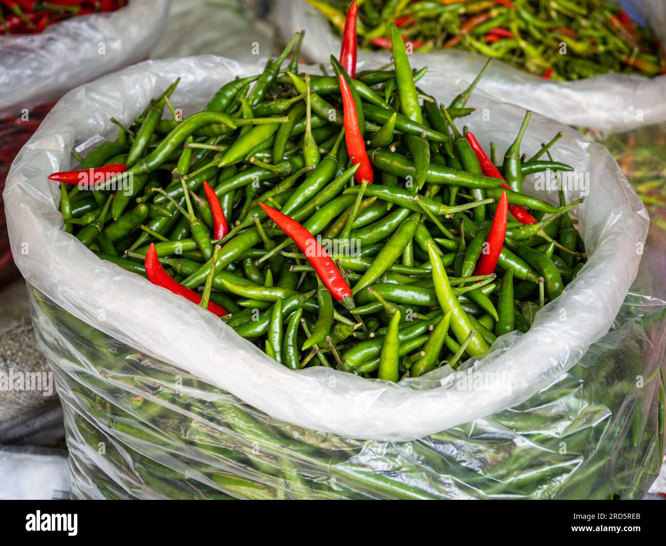In a bustling street market in Bangkok, Thailand, vibrant bags brim ...