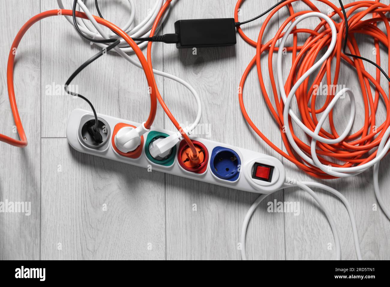Power strip with different electrical plugs on white laminated floor ...