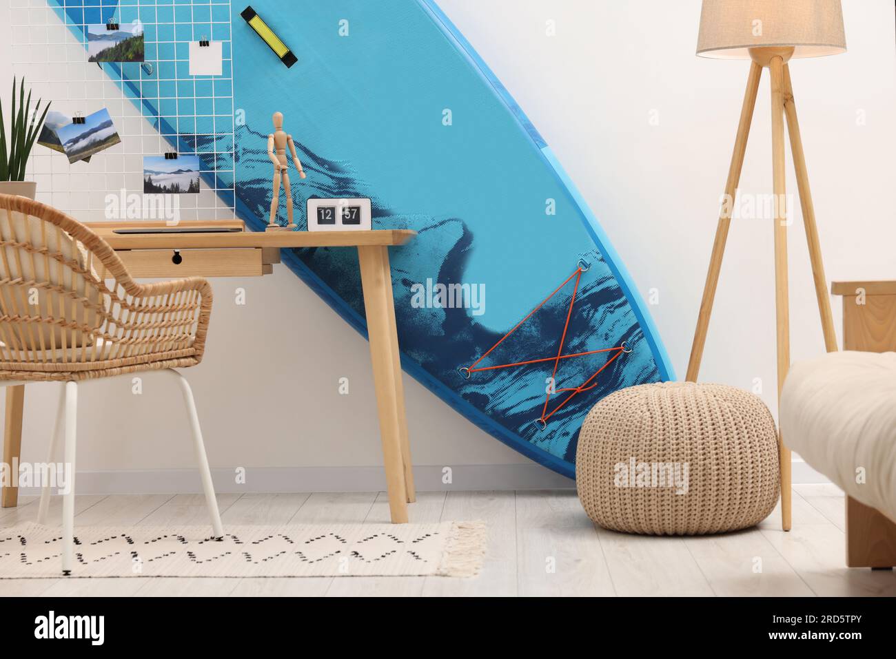 SUP board and workplace in room. Interior design Stock Photo - Alamy