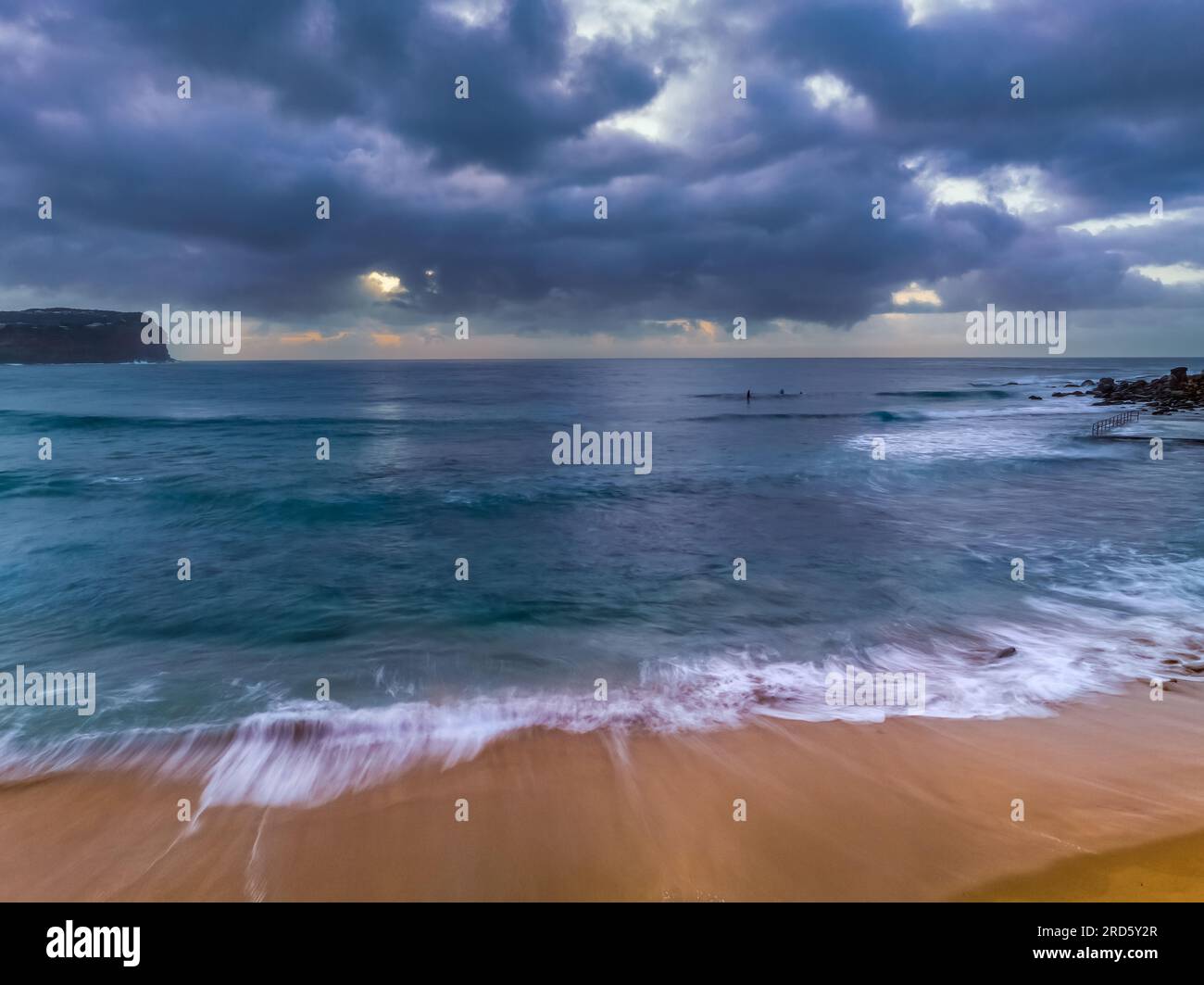 Aerial sunrise seascape with rain clouds and small waves at Macmasters ...