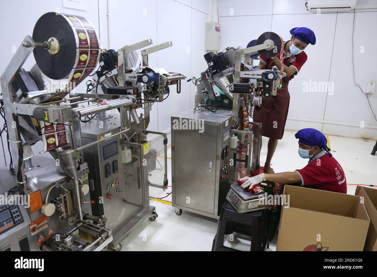 Yangon, Myanmar. 18th July, 2023. Workers pack coffee at a coffee ...