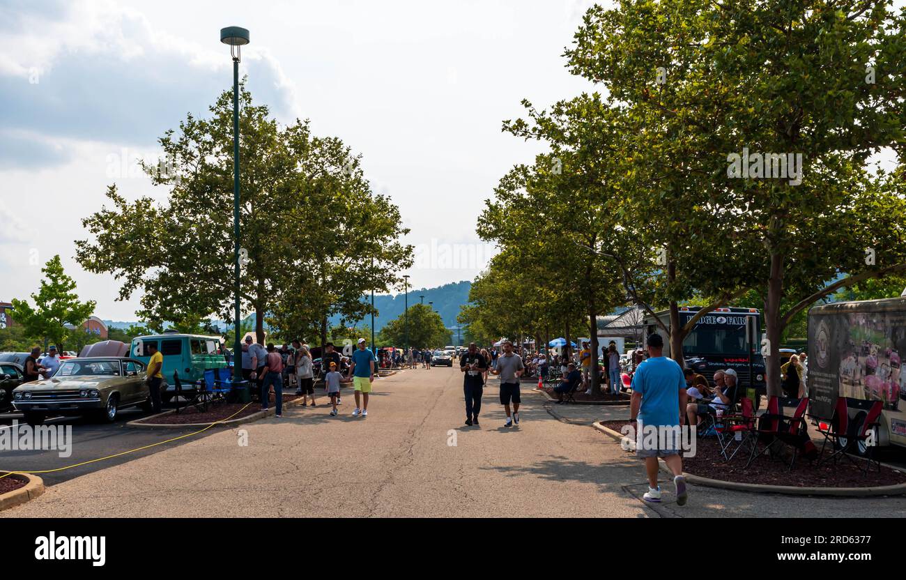 People walking around the cars at a car show in Homestead, Pennsylvania ...