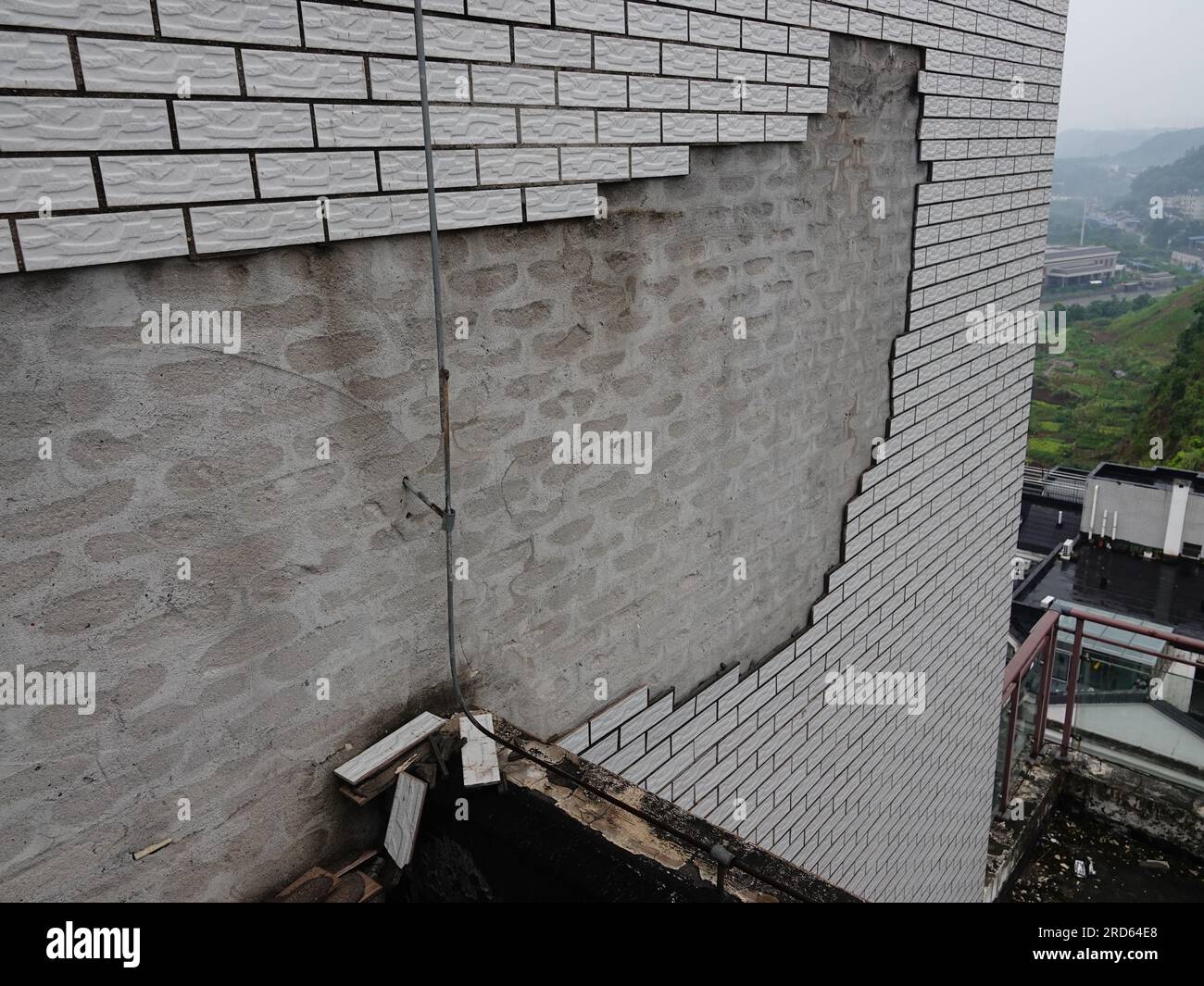 YICHANG, CHINA - JULY 19, 2023 - Tiles fall off the exterior wall of a ...