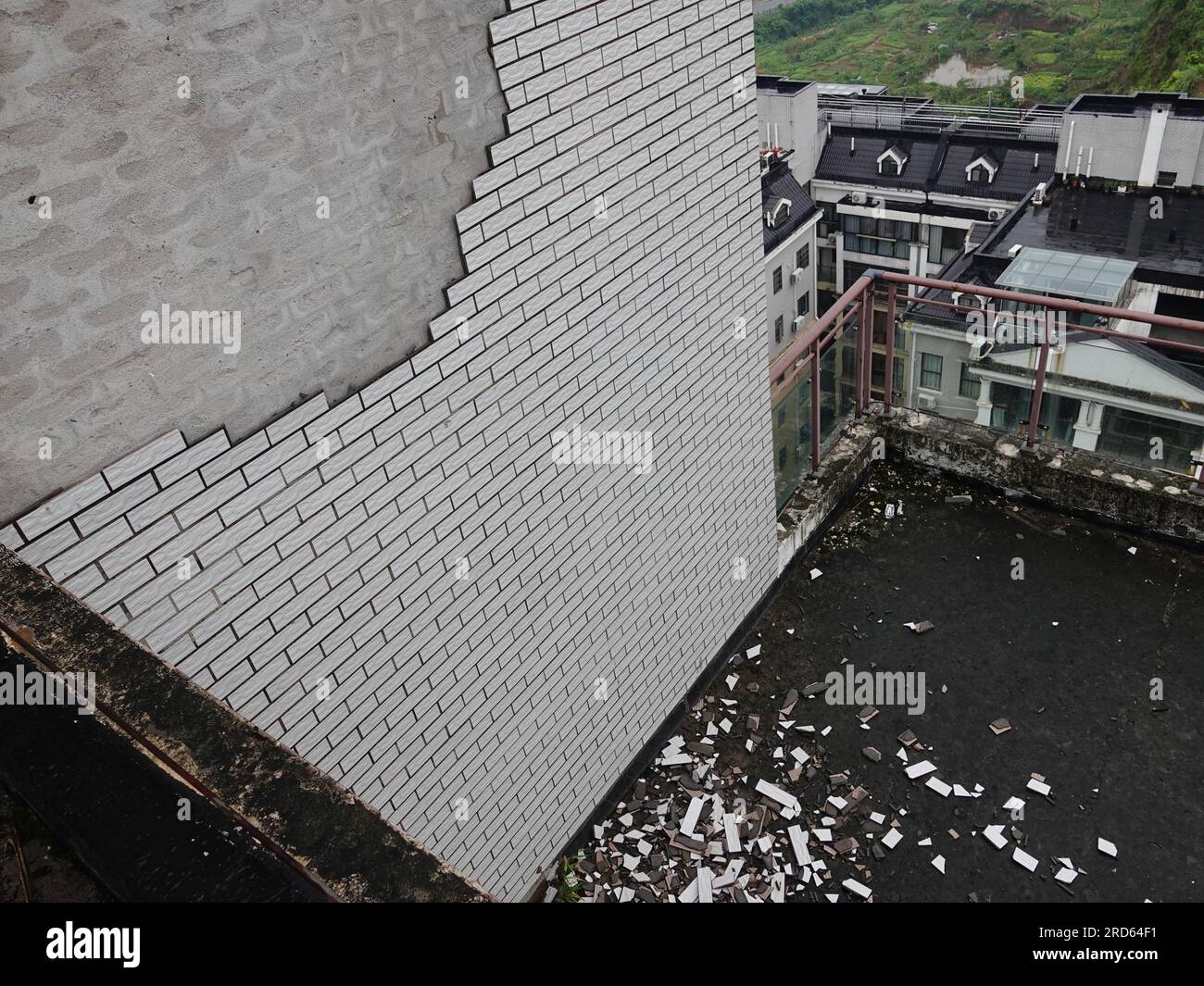 YICHANG, CHINA - JULY 19, 2023 - Tiles fall off the exterior wall of a ...
