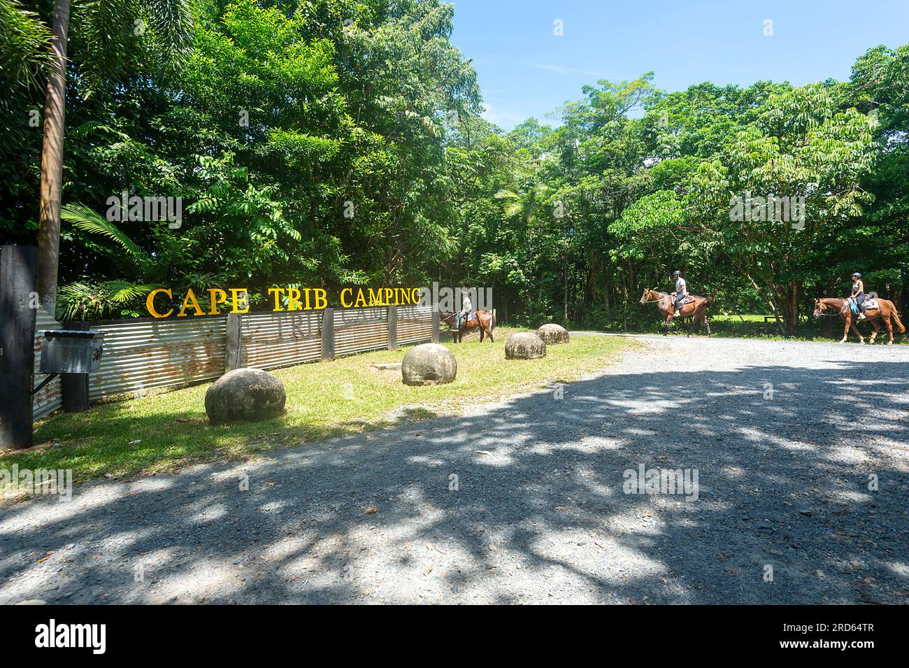 Horse riders riding past the entrance of the Cape Trib Camping in ...