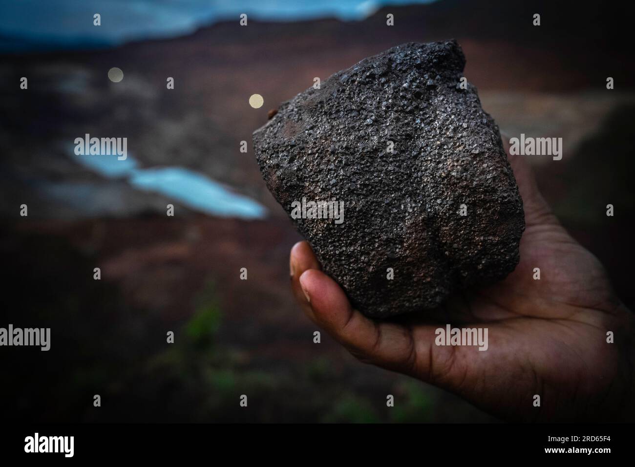 A mining engineer shows a piece of chromium ore at a mine near ...