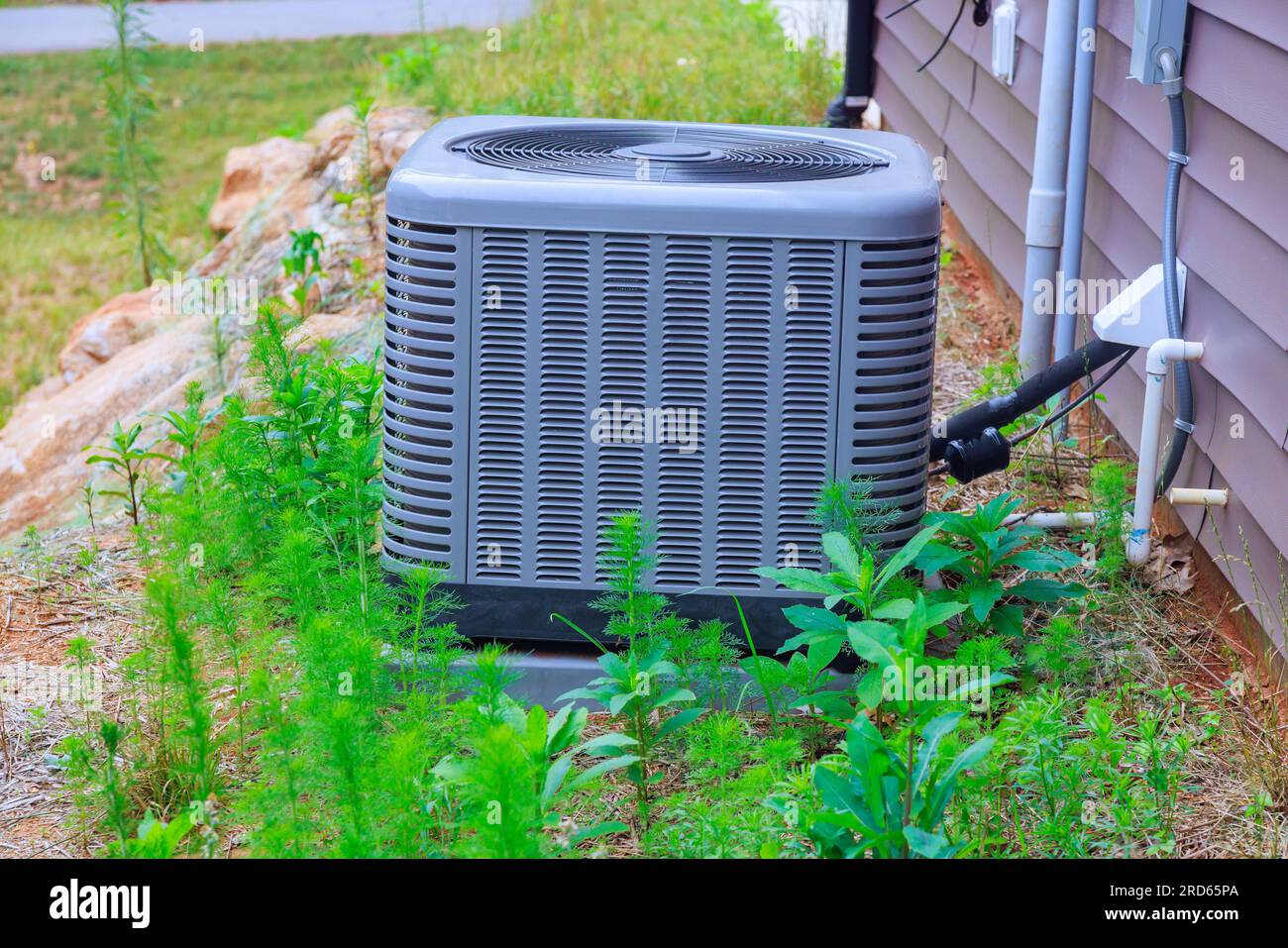 An outdoor air conditioning unit has been installed on house exterior ...