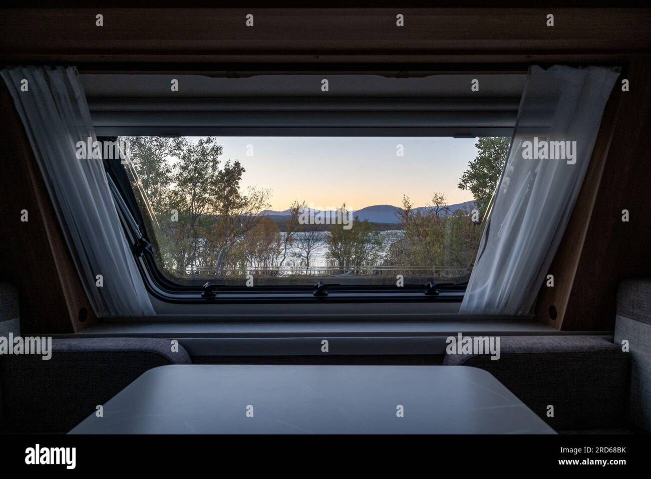 Sunset Autumn season in Abisko through a caravan window with Lake ...