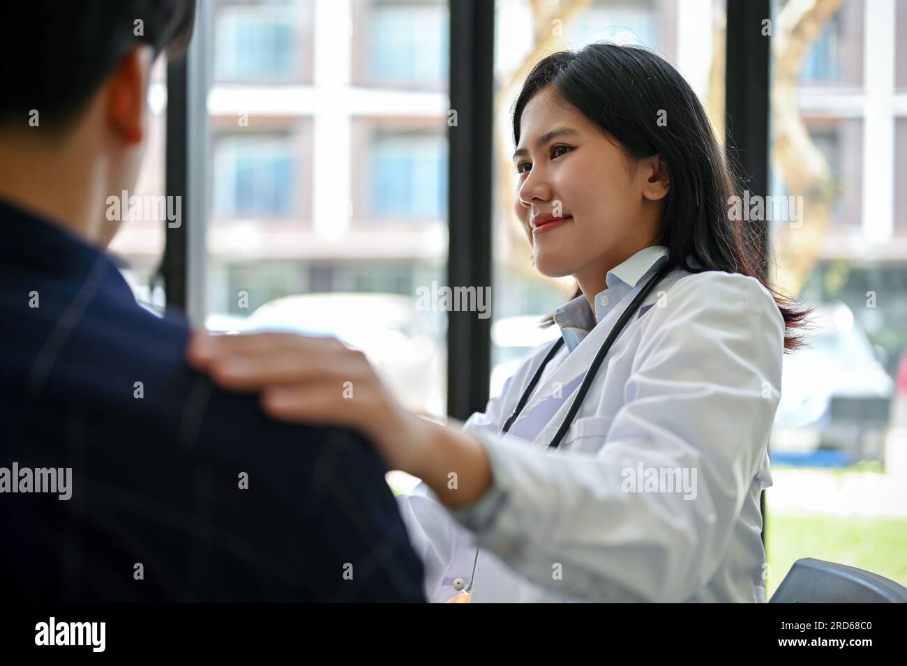 Close-up image of a professional Asian female doctor touching a patient ...
