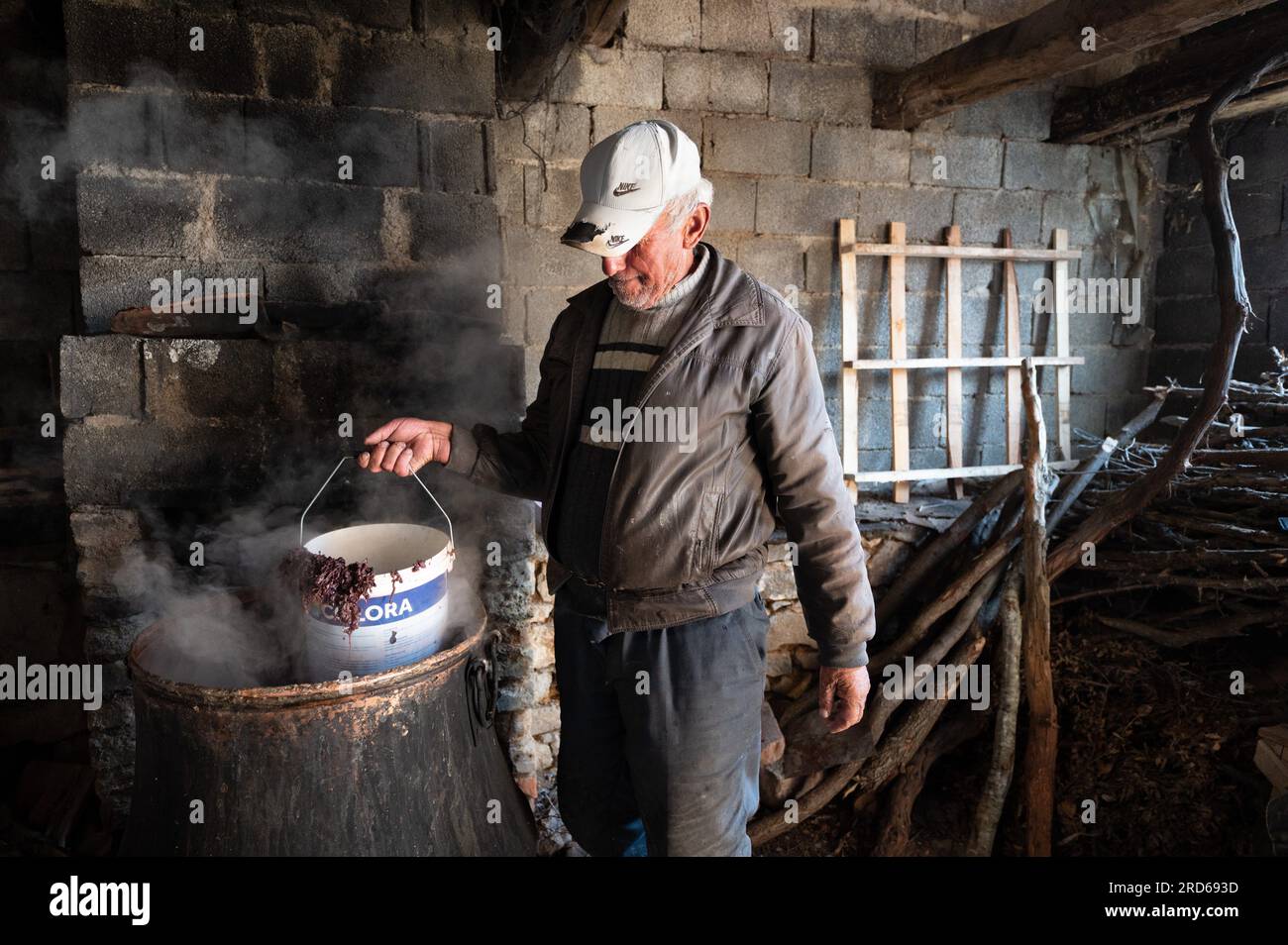 Lin, Albania. 01st May, 2023. A man scoops the mash from a copper ...