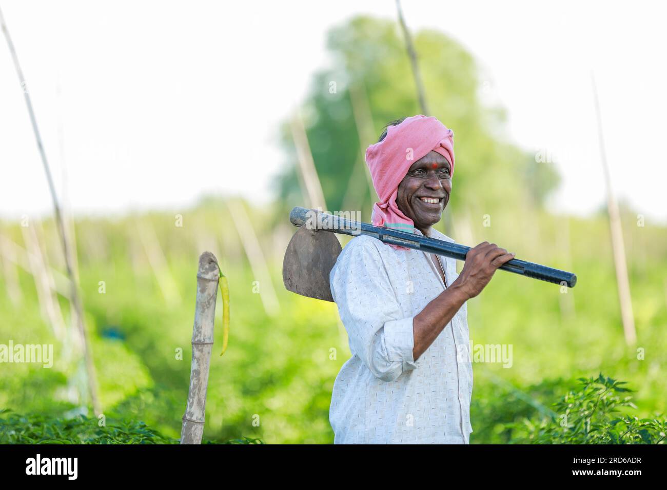 Happy Indian farmer, holding farming tools in hand Stock Photo - Alamy