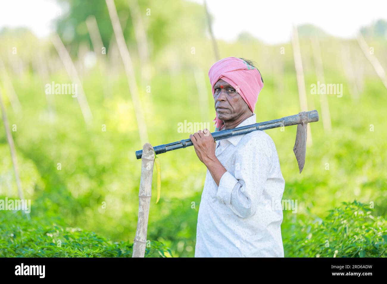 Happy Indian farmer, holding farming tools in hand Stock Photo - Alamy