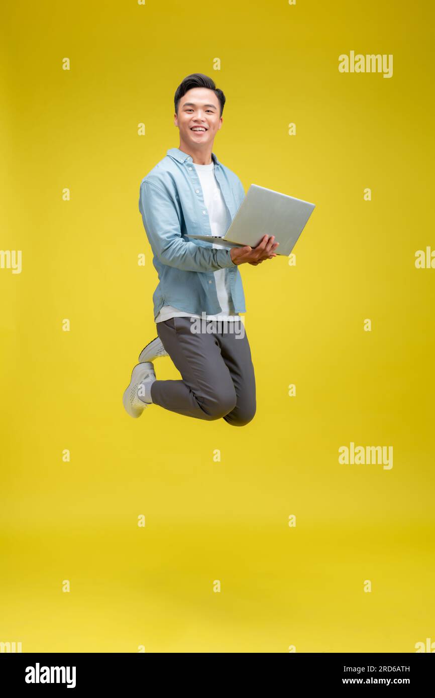 happy excited young african man jumping isolated over yellow background ...