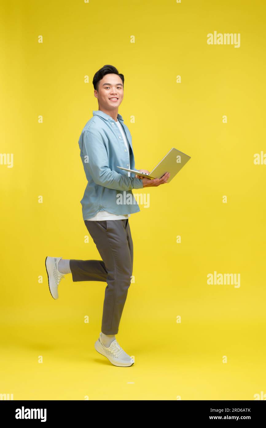 happy excited young african man jumping isolated over yellow background ...