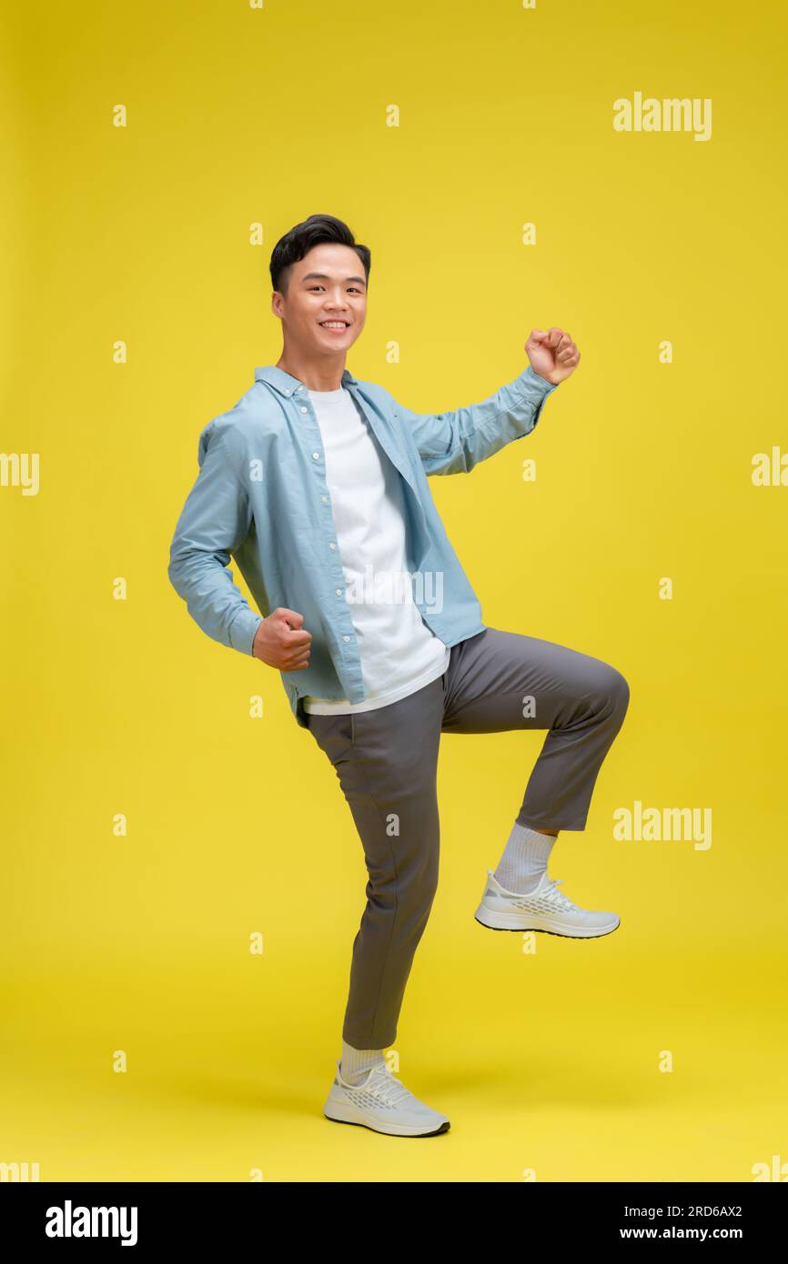 Young man very happy and excited doing winner gesture with arms raised ...