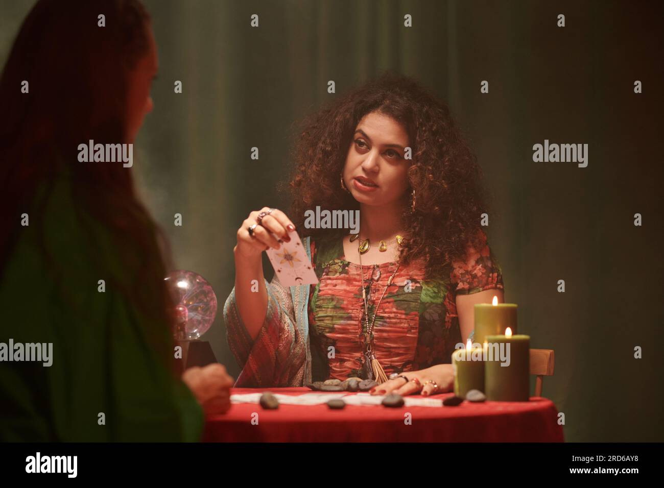 Serious tarot cards reader talking to client and giving her advice on ...