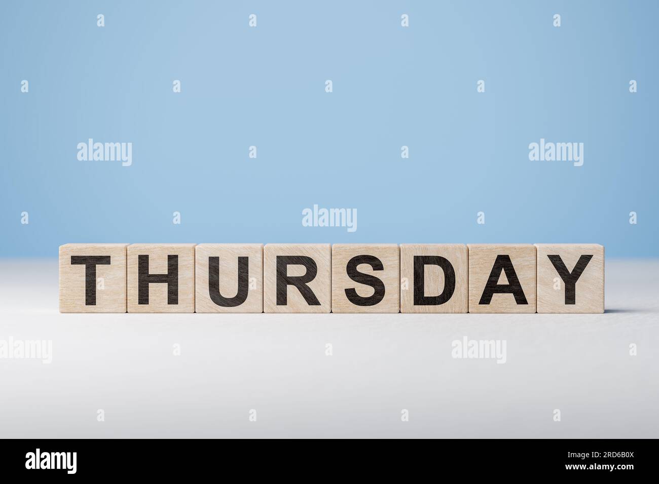 Text Thursday on wooden cubes on blue background. Day of week on wood ...