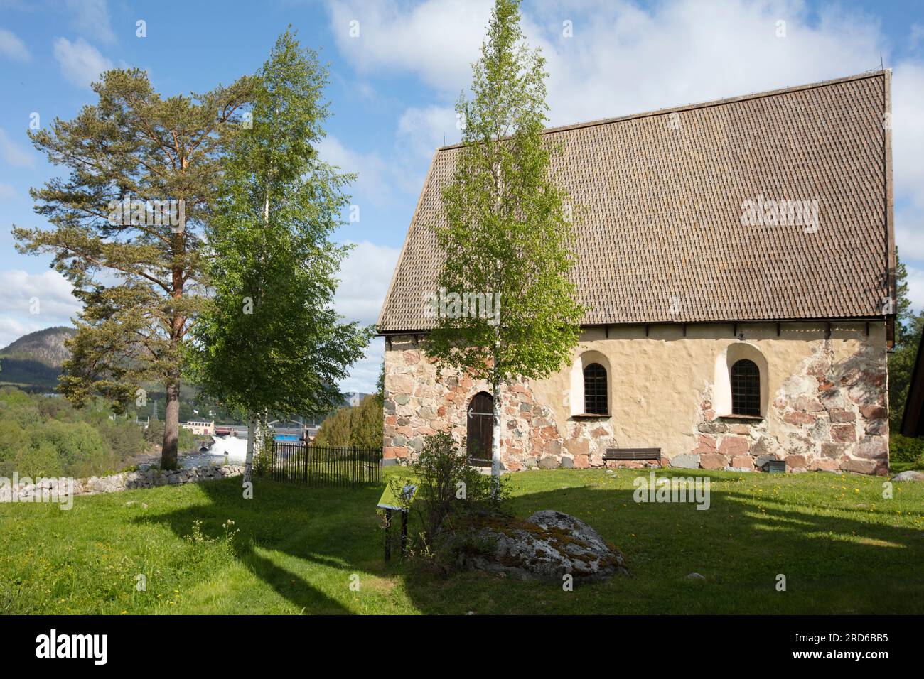 RAGUNDA, SWEDEN ON JUNE 07, 2023. View of an old stone church. River in ...