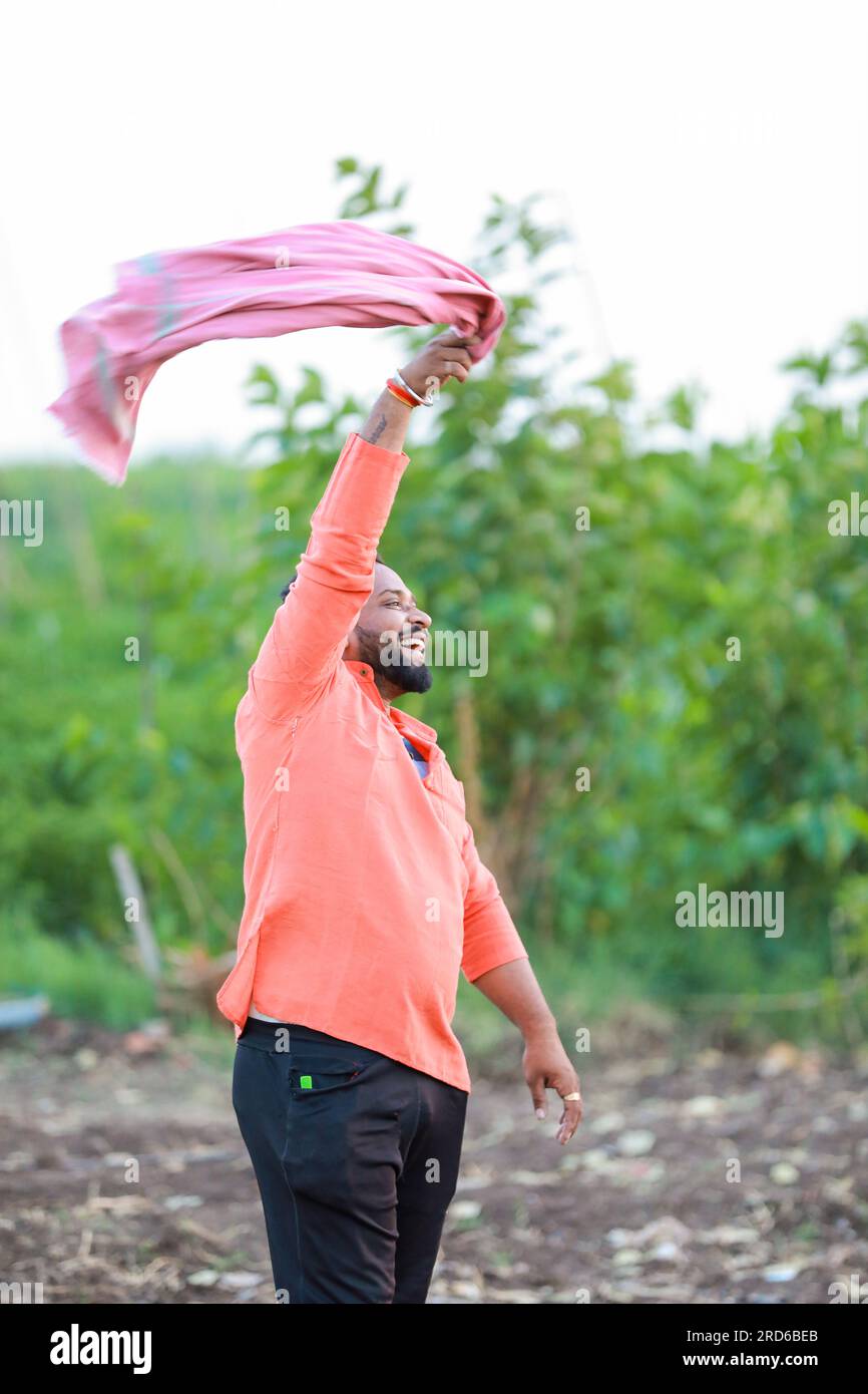 happy Indian farmer standing in green Chilli farm Stock Photo - Alamy
