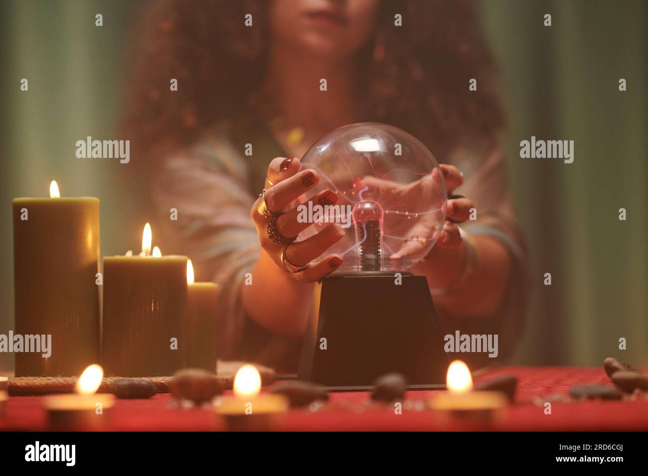 Closeup image of fortune teller touching crystal ball trying to see ...