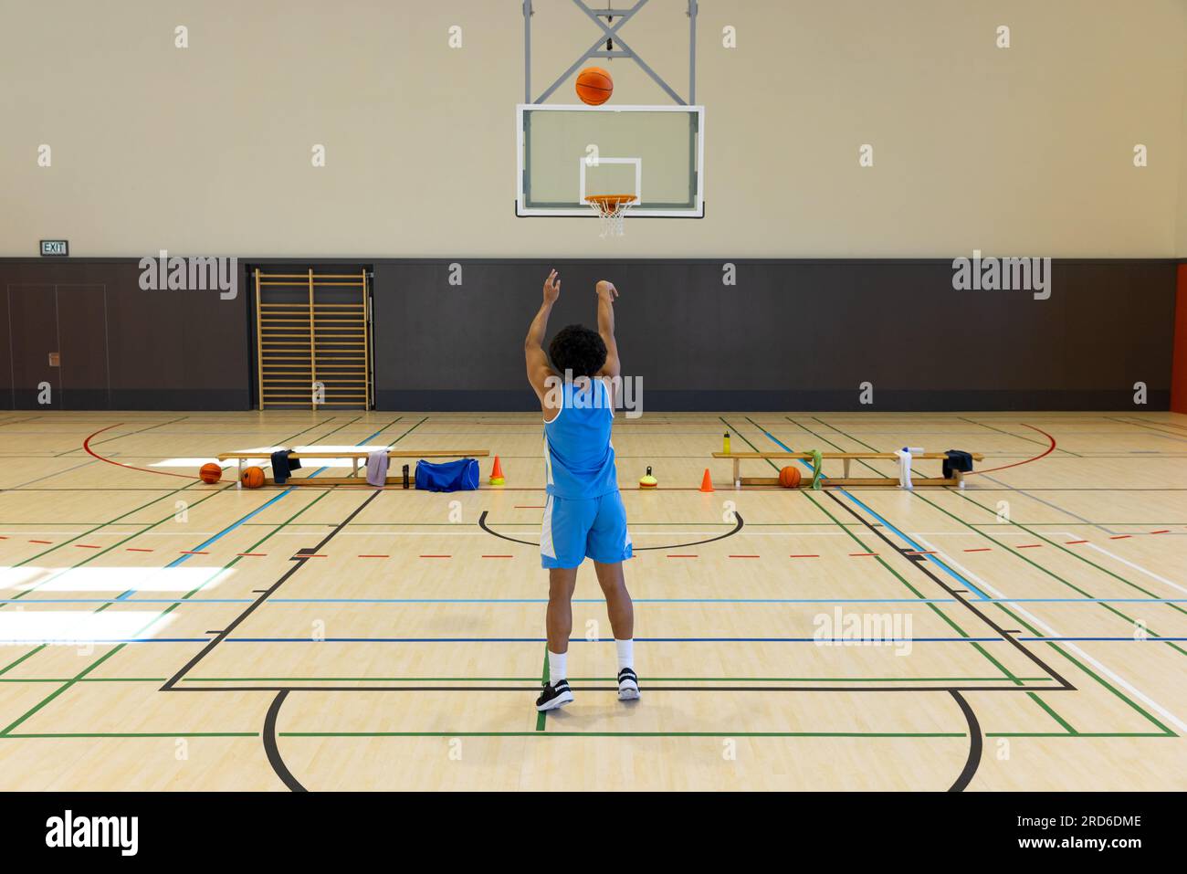 Biracial male basketball player wearing blue sports clothes and ...