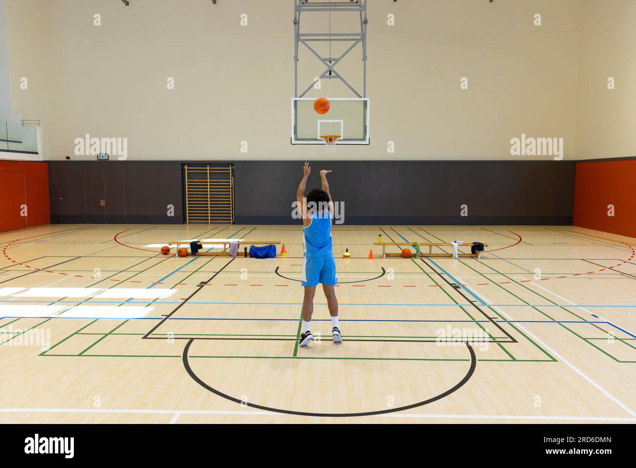 Biracial male basketball player wearing blue sports clothes and ...