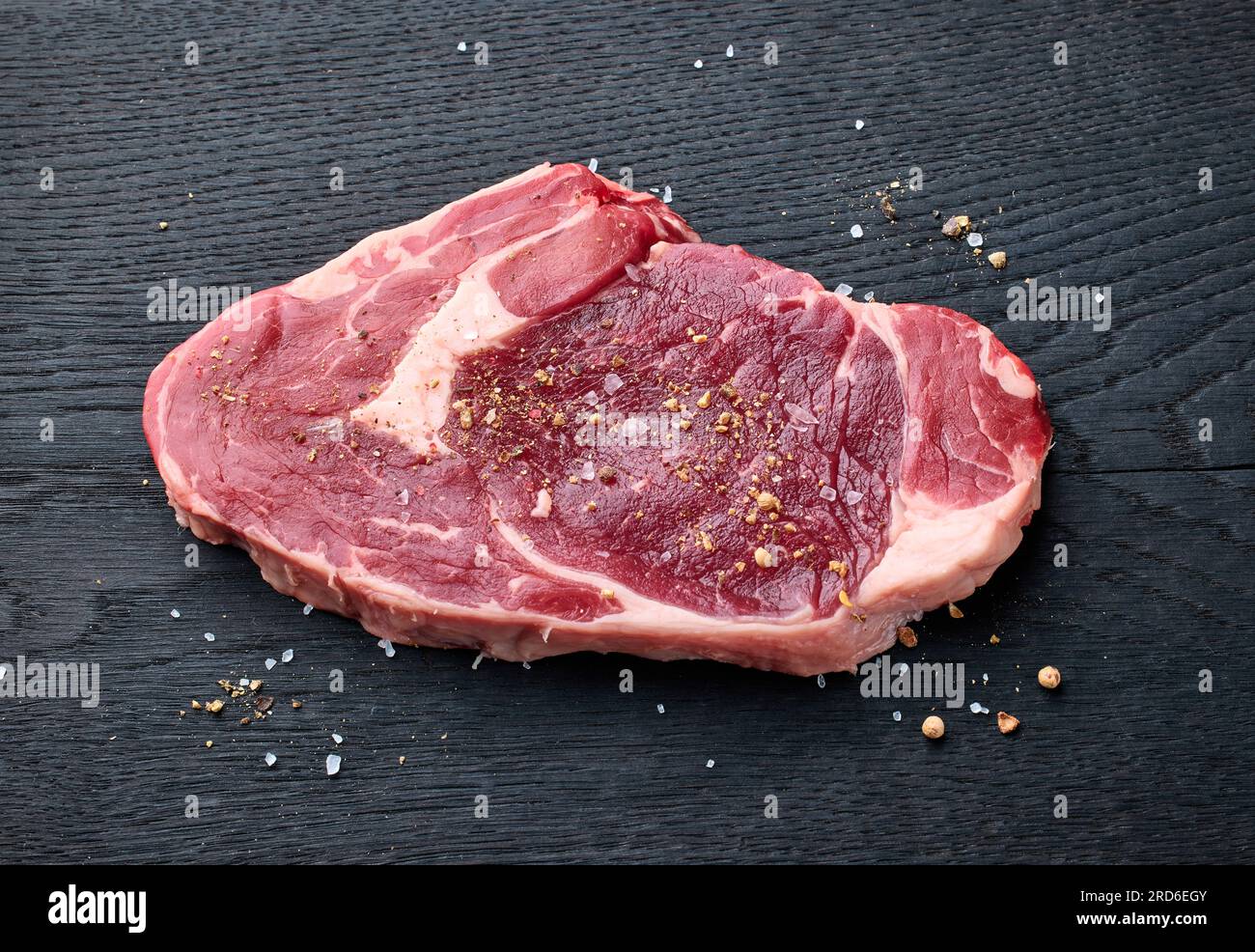 fresh raw beef entrecote steak on black wooden board, top view Stock ...