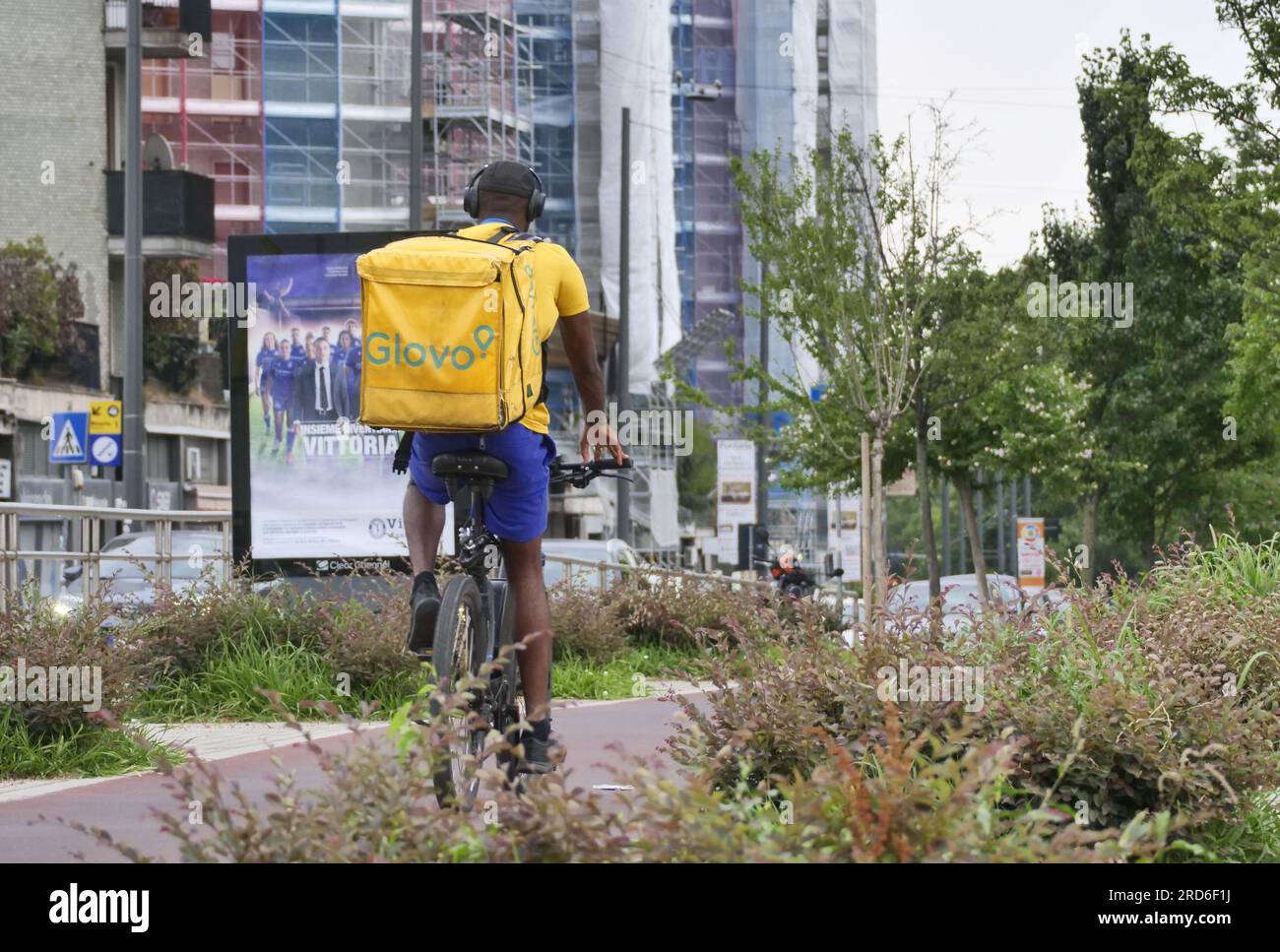 Bicycle food delivery rider working in the street of Milan before ...