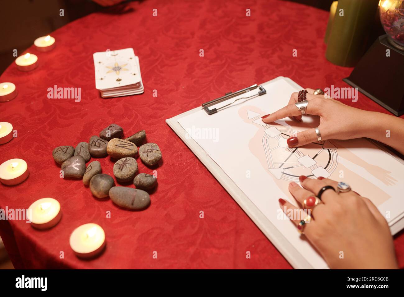 Closeup image of fortune teller analyzing chakra chart of client Stock ...