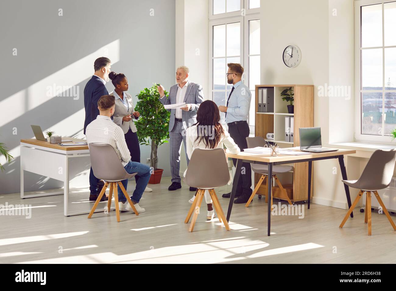 Group of diverse business people working and communicating during ...