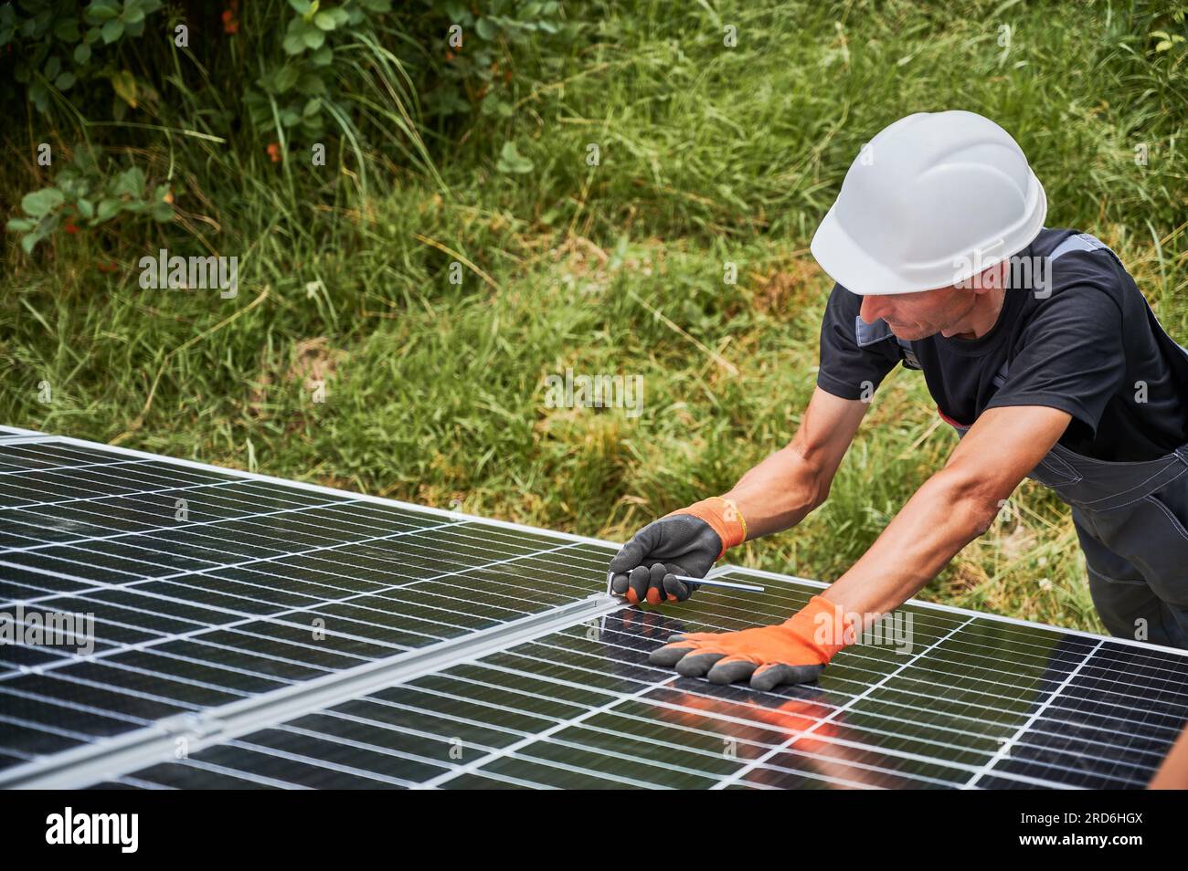 Male worker mounting photovoltaic solar panel system outdoors. Man ...