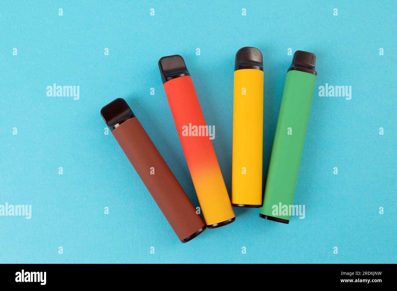 Set of colorful disposable electronic cigarettes on a blue background ...