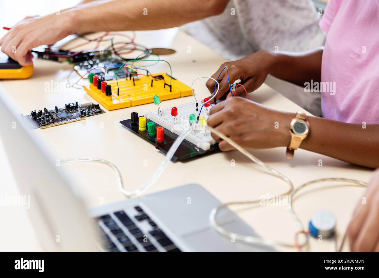 Close-up view of young students learning electronic circuit system at ...