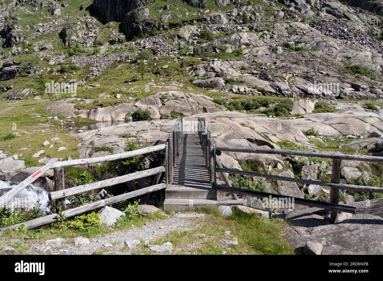 wooden bridge of the path that leads to the cornisello lakes in the ...