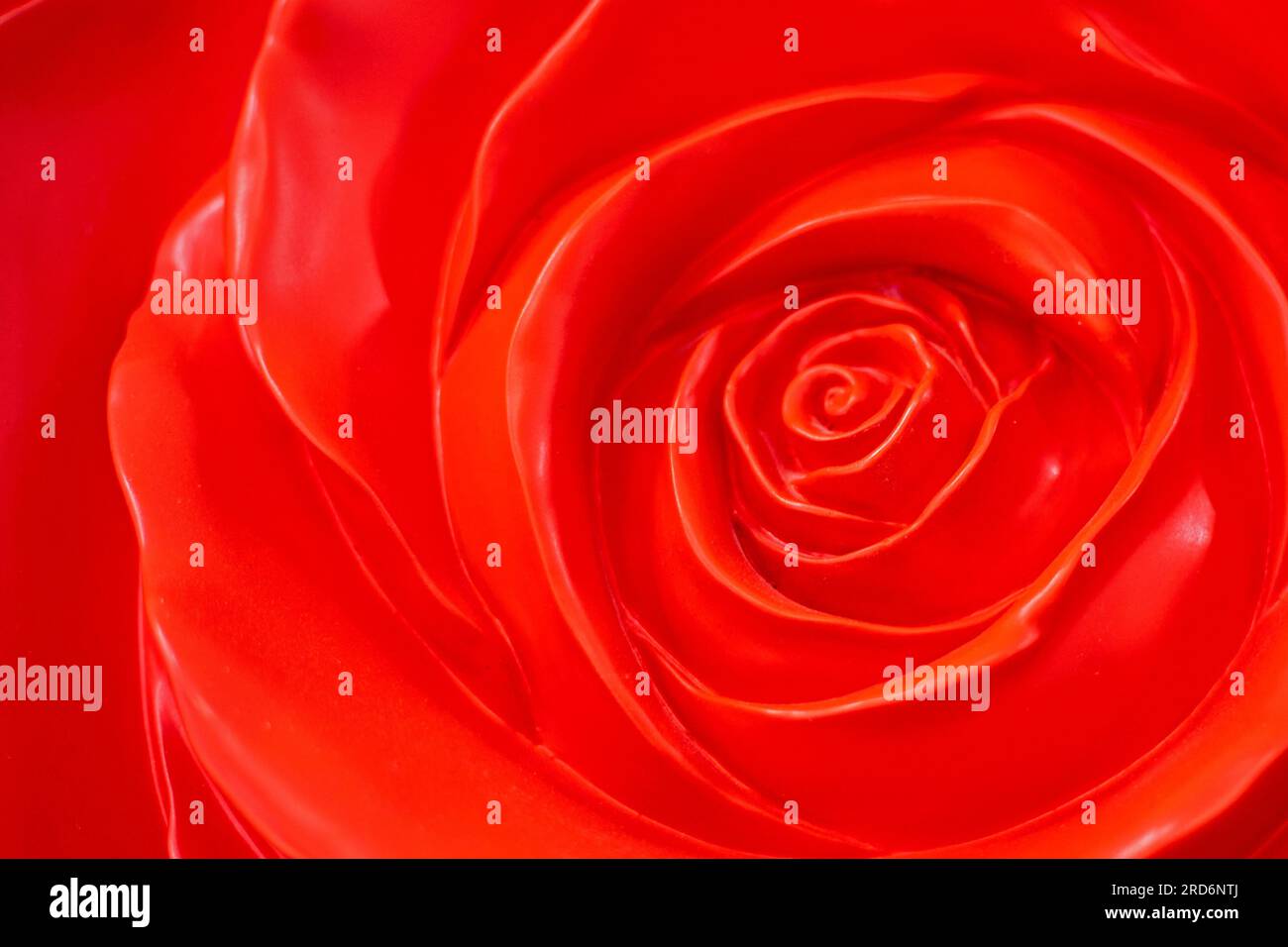 abstract red background of clay relief of a rose flower. modern ...