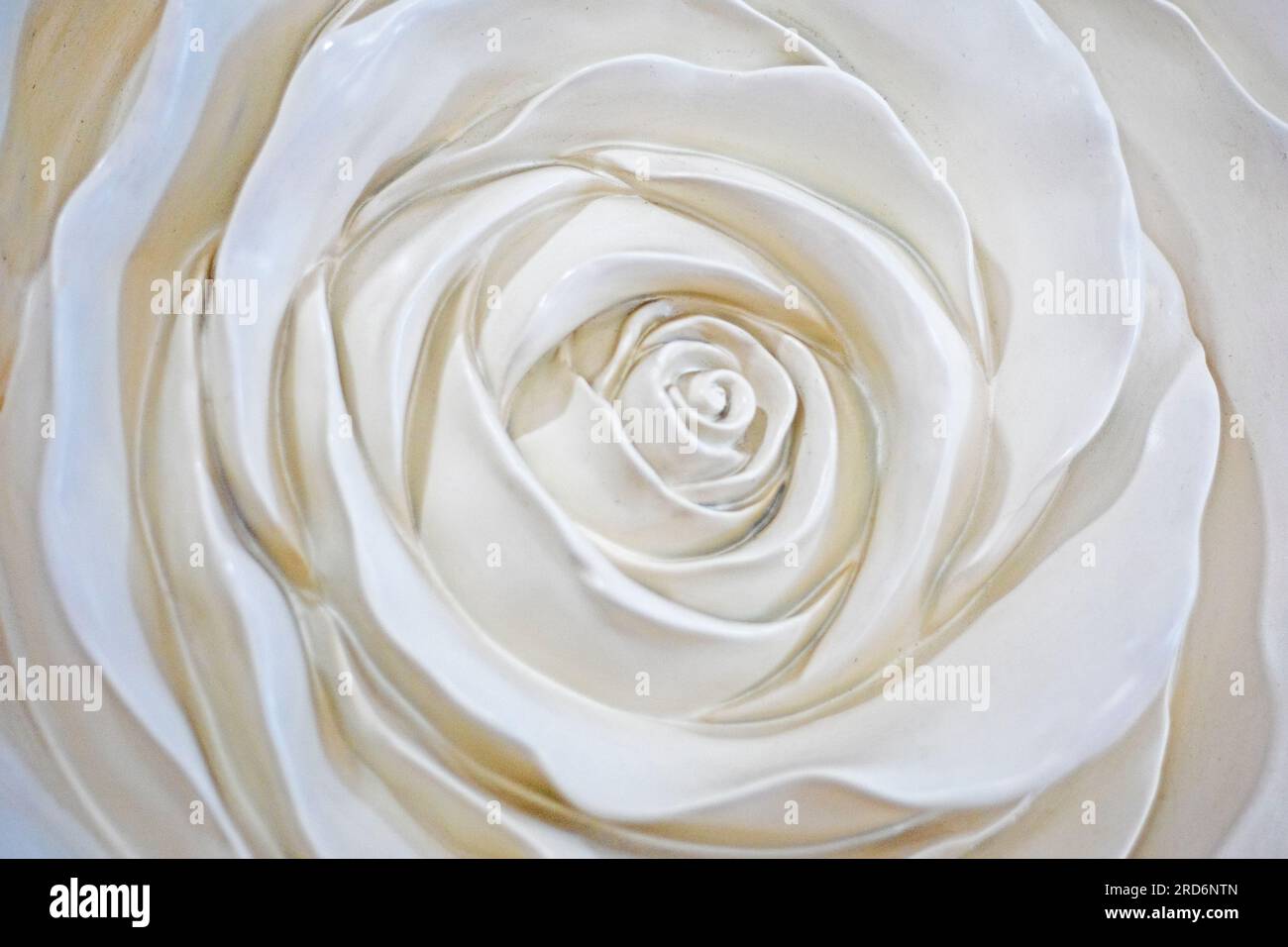 abstract light background of the core of a rose flower molded from clay ...