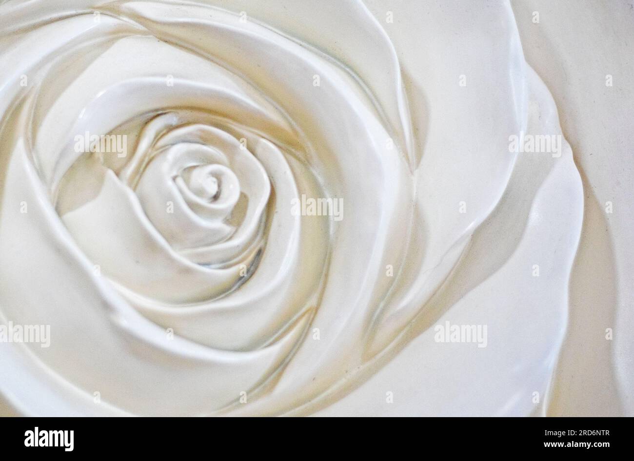 abstract light background of the core of a rose flower molded from clay ...