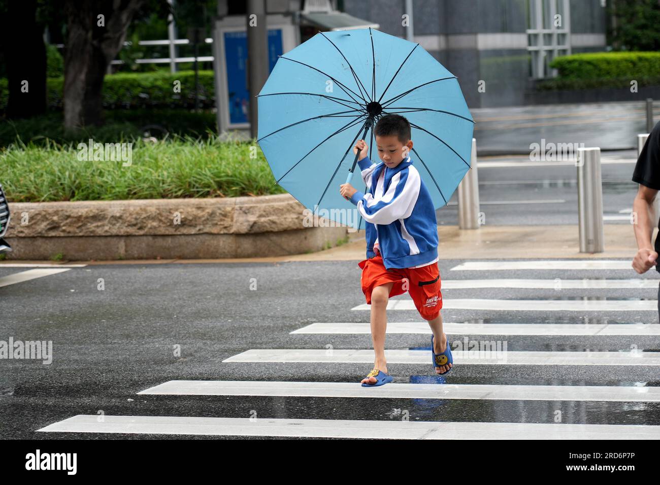 Local residents travel out in rain and wind as typhoon Talim approaches ...