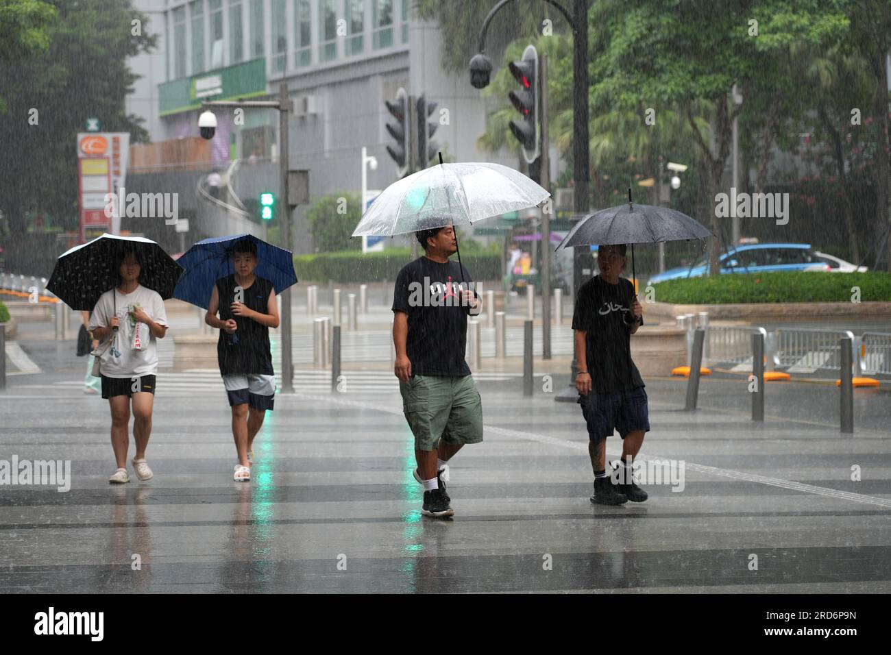 Local residents travel out in rain and wind as typhoon Talim approaches ...