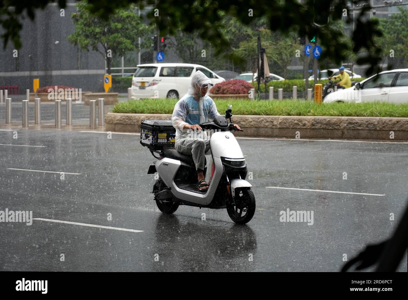 Local residents travel out in rain and wind as typhoon Talim approaches ...