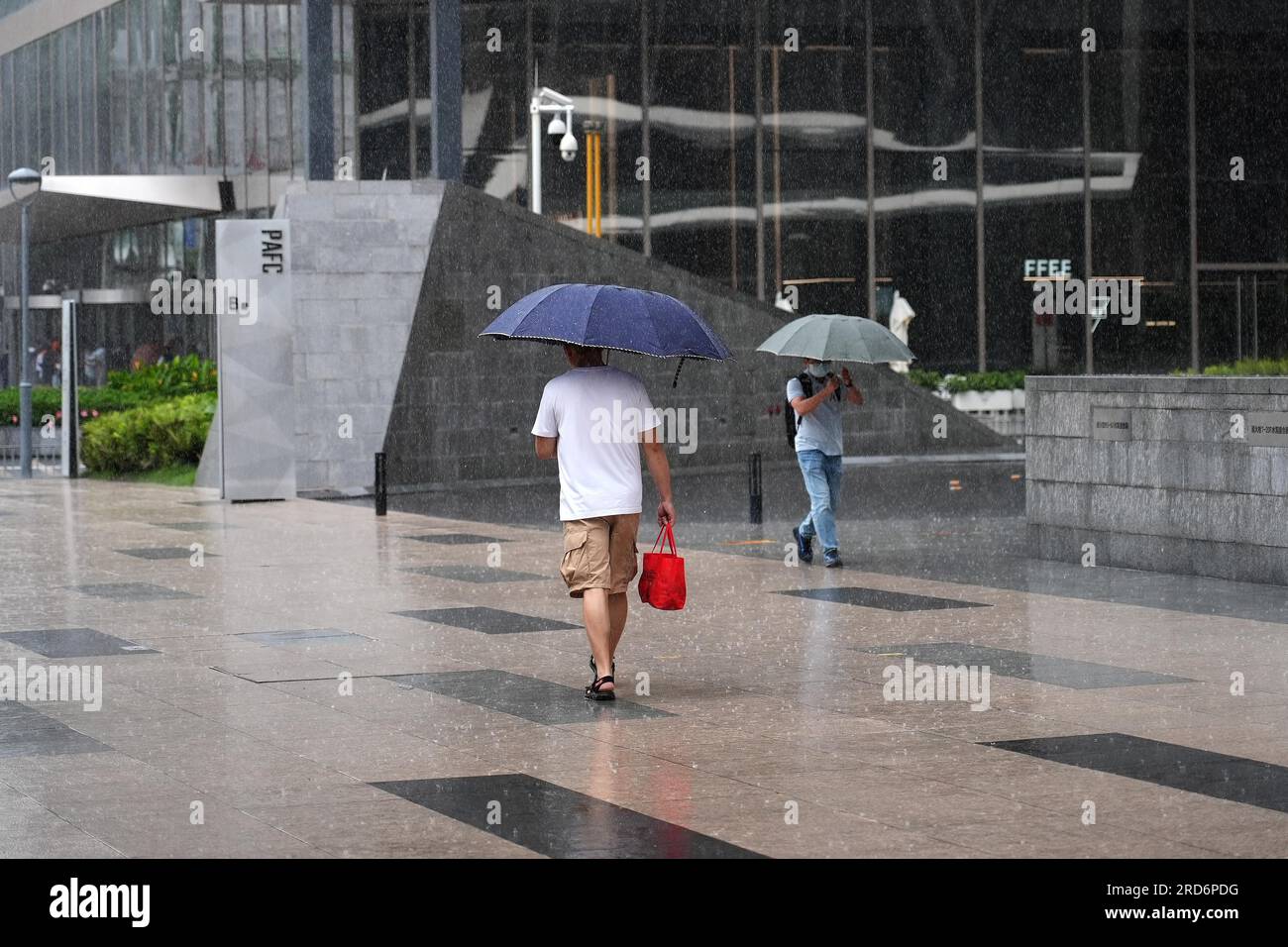 Local residents travel out in rain and wind as typhoon Talim approaches ...