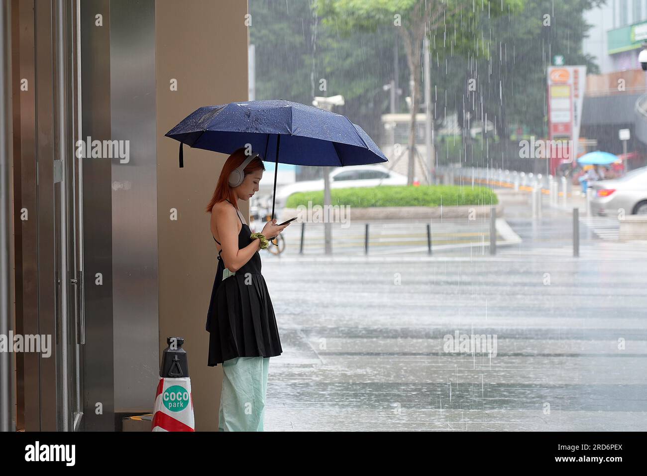 Local residents travel out in rain and wind as typhoon Talim approaches ...