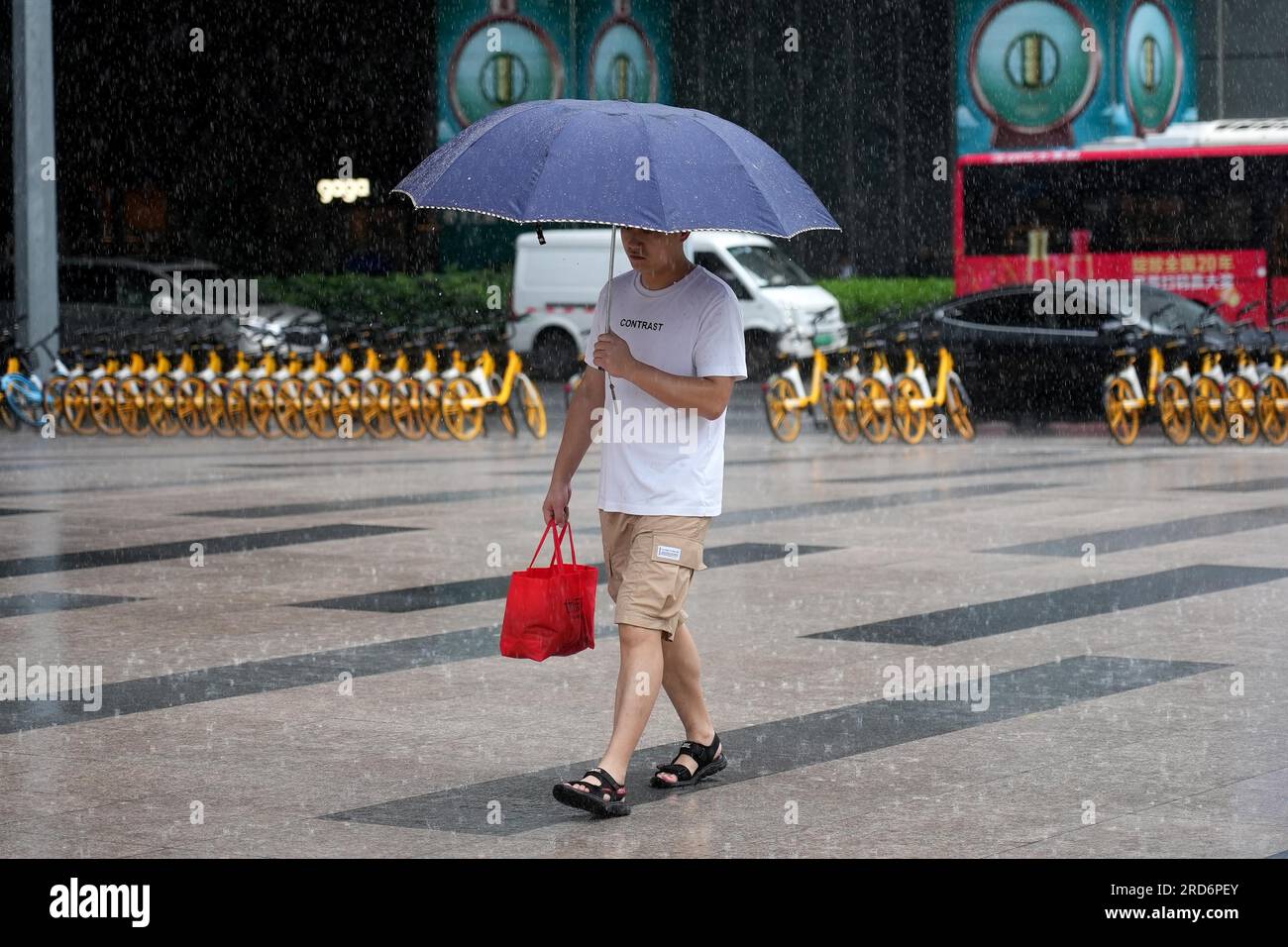Local residents travel out in rain and wind as typhoon Talim approaches ...