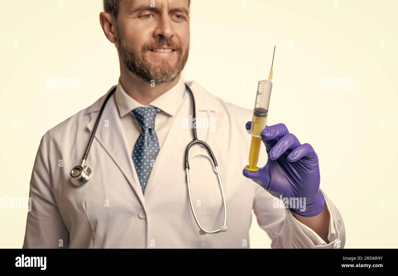 Man doctor holding medical syringe. Medic prepared injection syringe ...