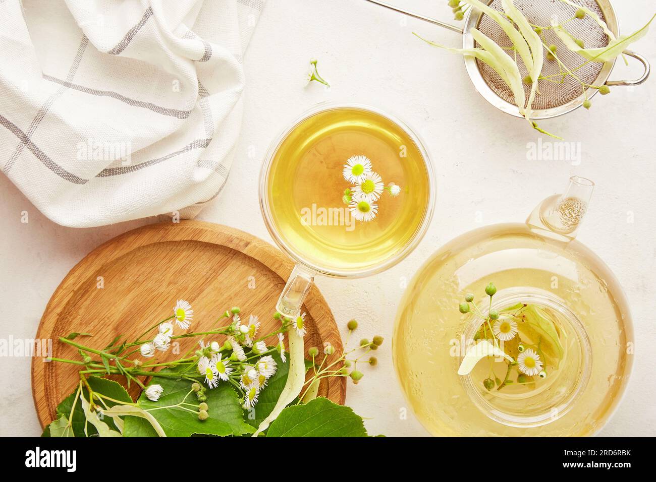 Infuser, teapot, cup of healthy organic herbal linden, chamomile tea ...