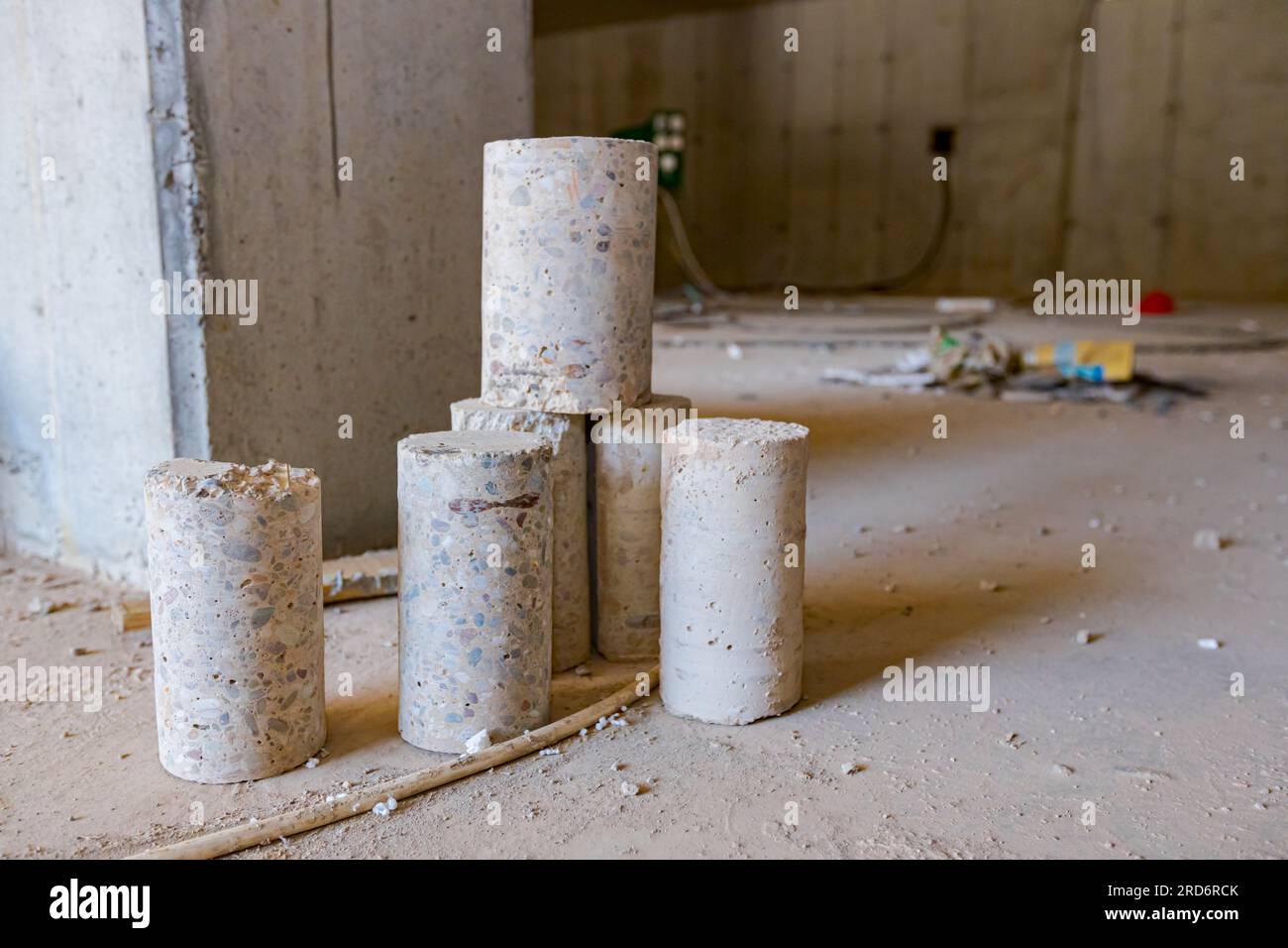A few concrete cylindrical pillars placed on the floor of building ...