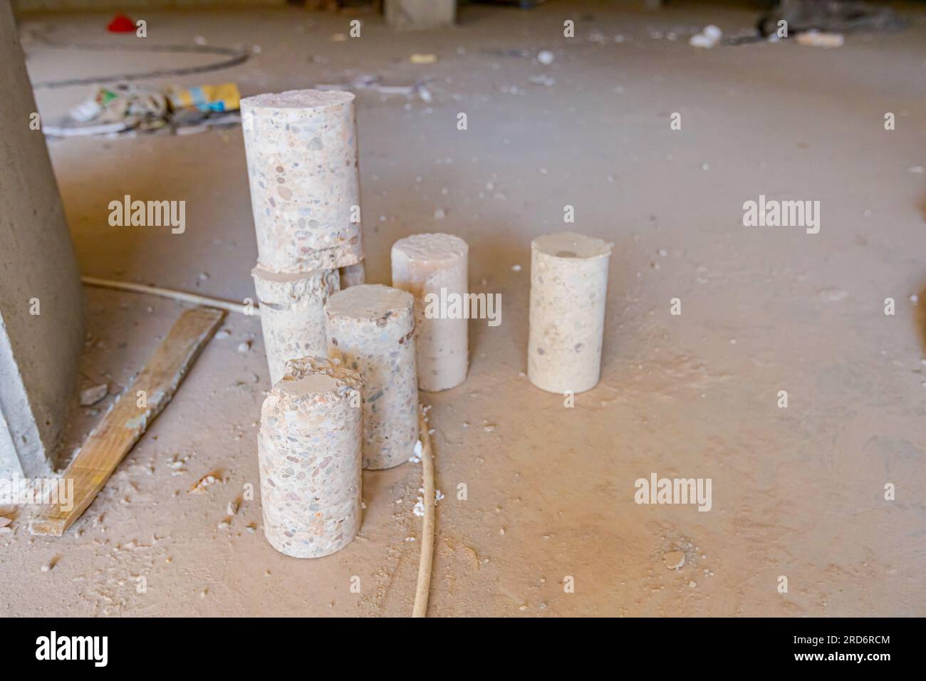 A few concrete cylindrical pillars placed on the floor of building ...
