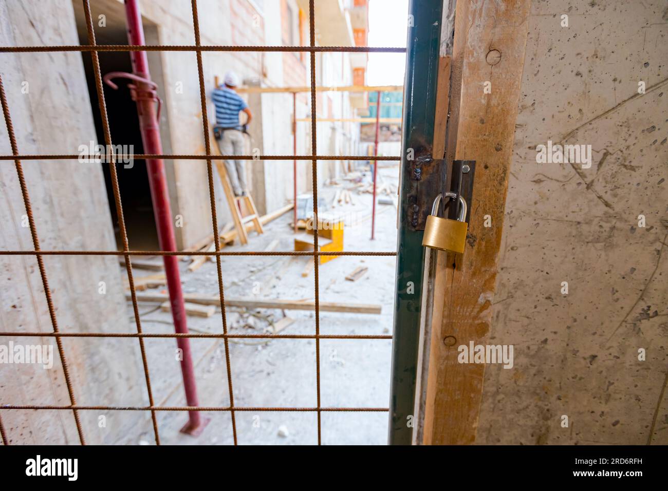 Close up view on metal lattice door, as a barrier, locked up with ...