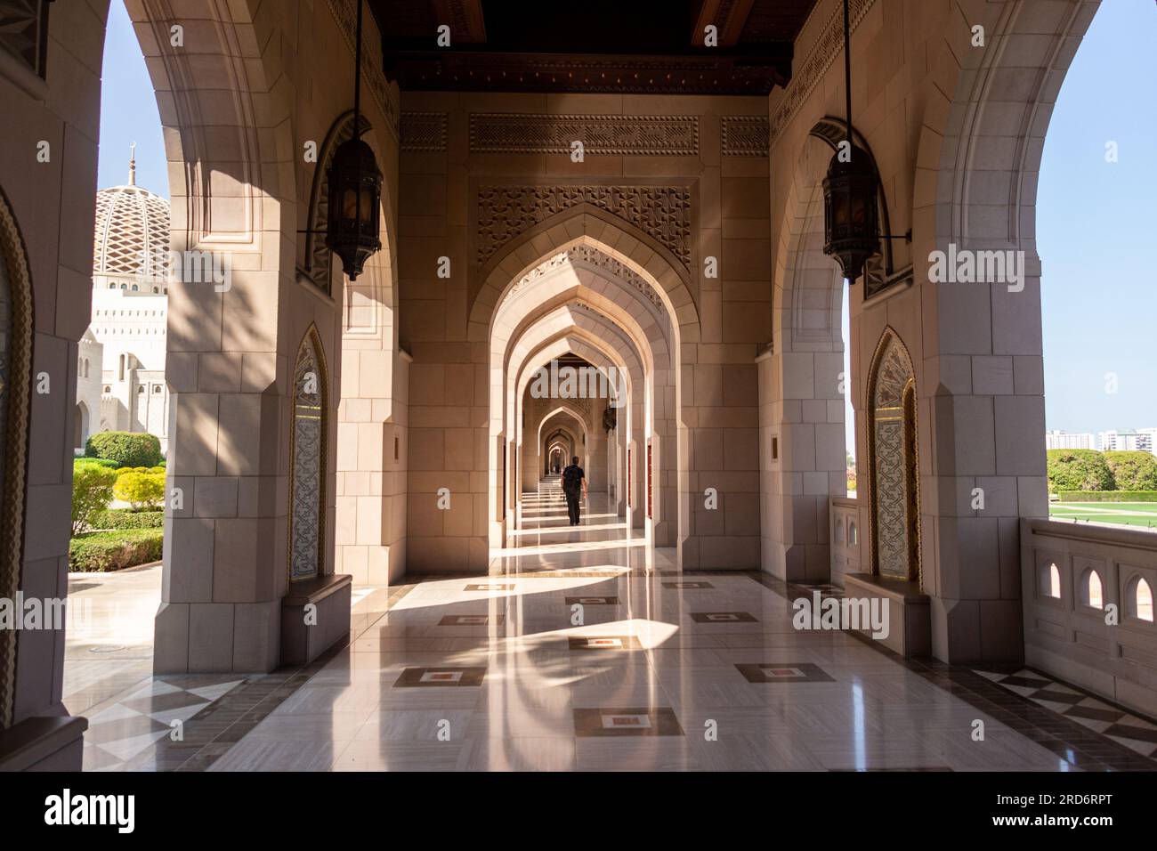A man walks through a beautifully lit corridor at the Sultan Qaboos ...
