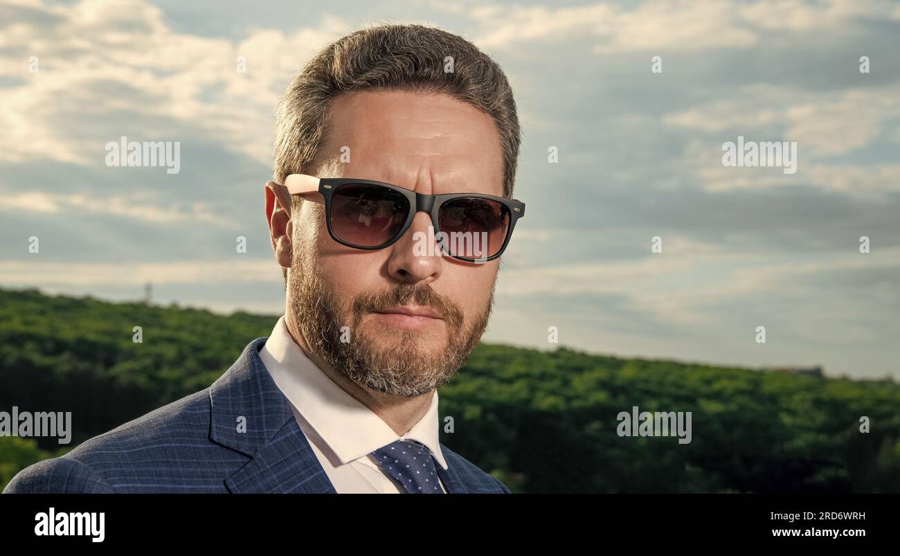 Portrait of serious man wearing sunglasses. Grizzled man with unshaven ...